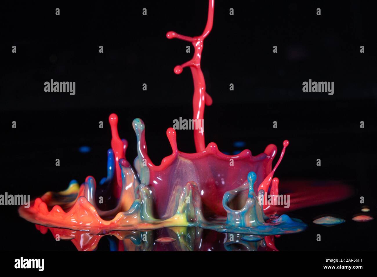 Color ink splash on a black background Stock Photo - Alamy