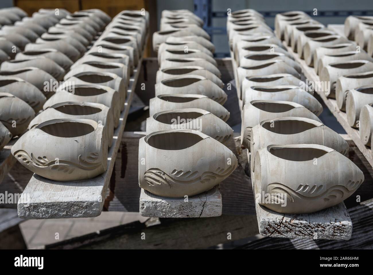 Handmade vessels drying on sun in front of Black Ceramics of Marginea ...