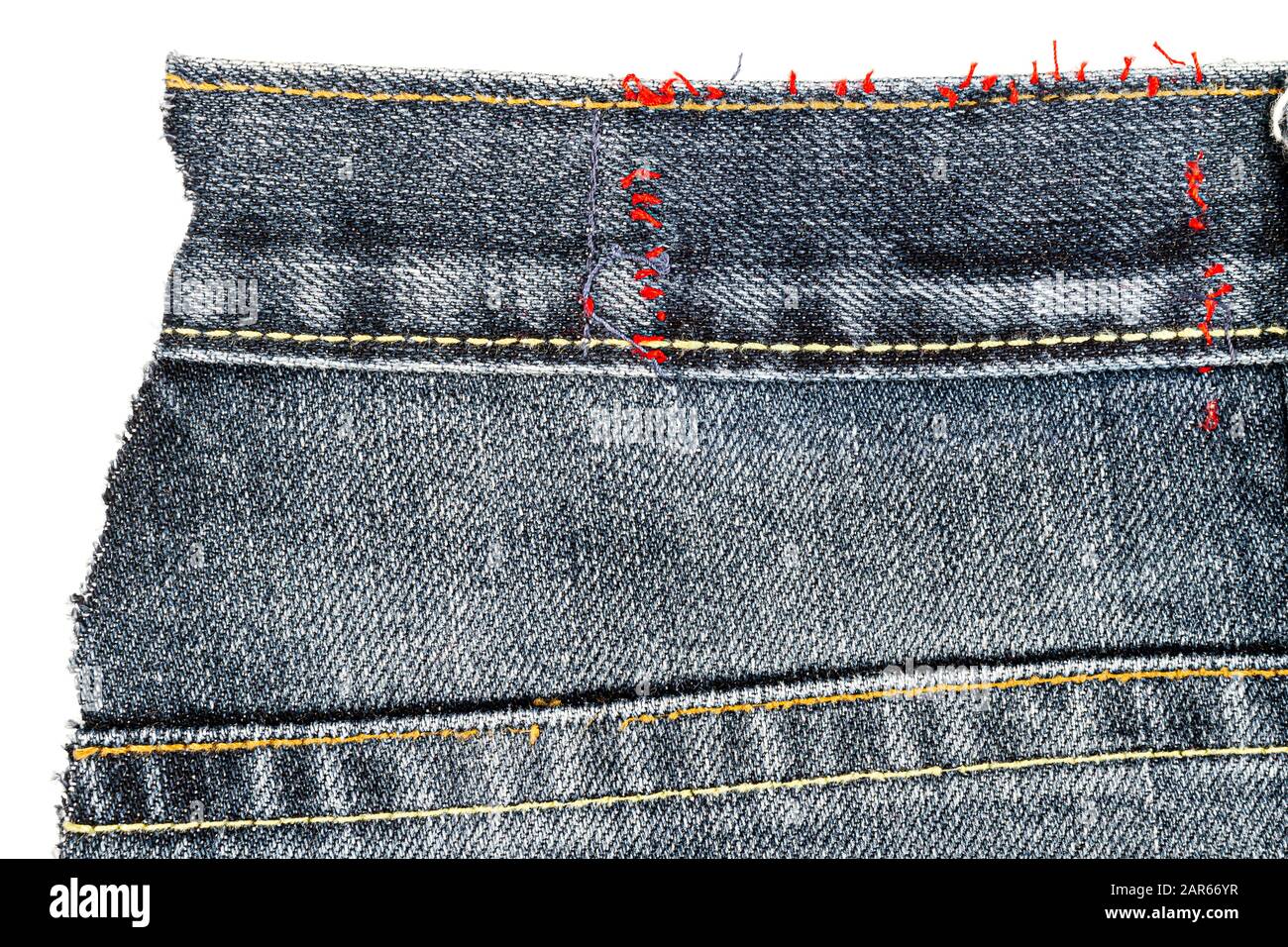 Piece of black jeans fabric with a ripped of label isolated on white ...