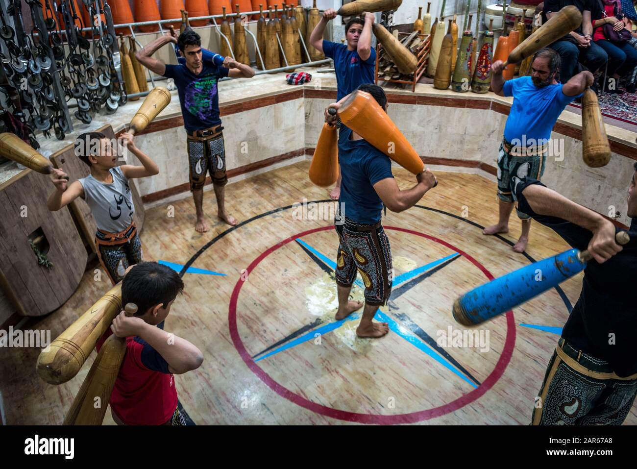 Iranian men and boys training with wooden clubs in Zoorkhaneh (House of ...