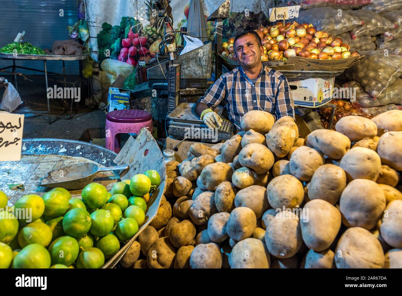 Iranian men selling vegetables on small market place in Shiraz city ...