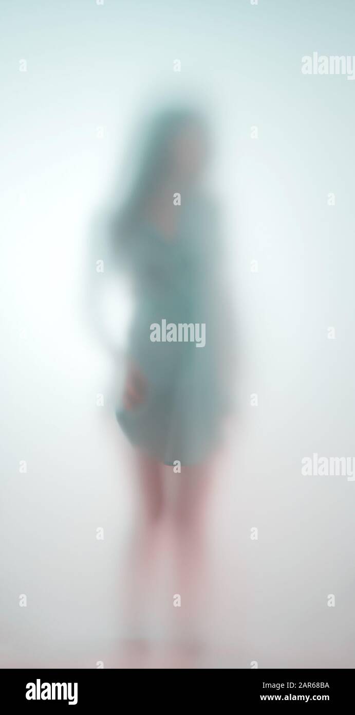 Blurred photo girl wearing dress dancing behind glass Stock Photo - Alamy