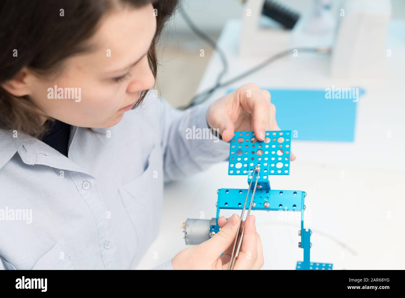 Student woman in robotics laboratory working on project mechatronics ...
