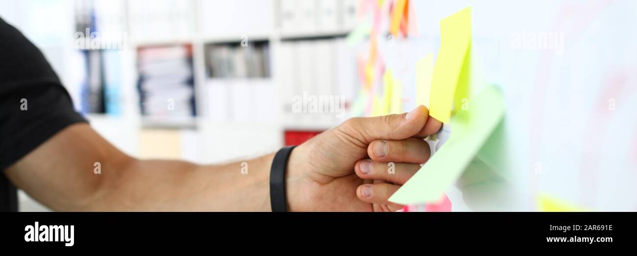 Male arm tearing away sticky paper note from whiteboard Stock Photo - Alamy