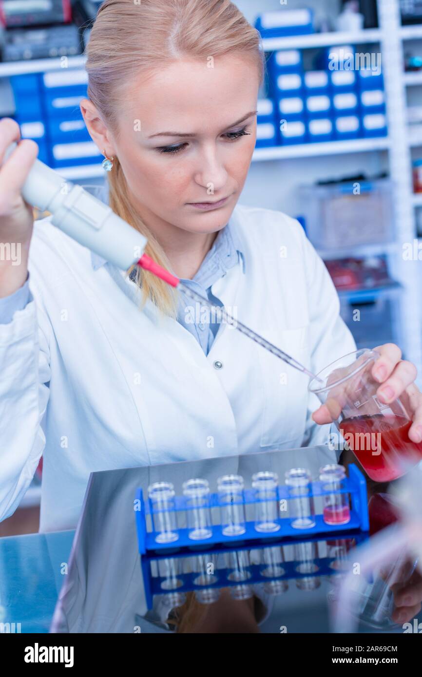 Girl laboratory Assistant works with an antiviral drug in a ...