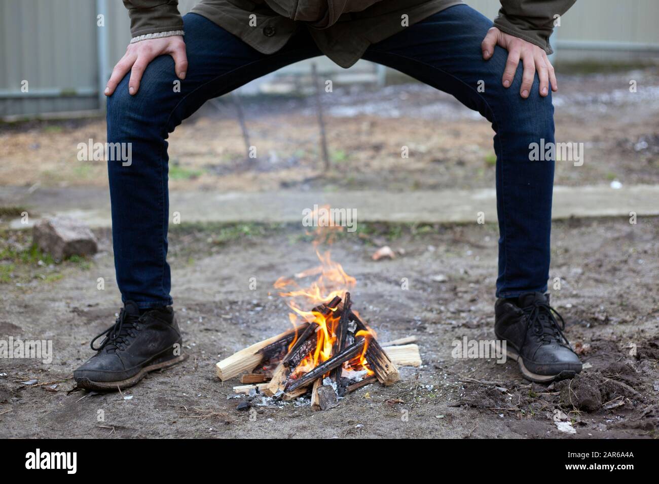 jumping over a bonfire celebrating Shrovetide. a guy stands over a fire ...