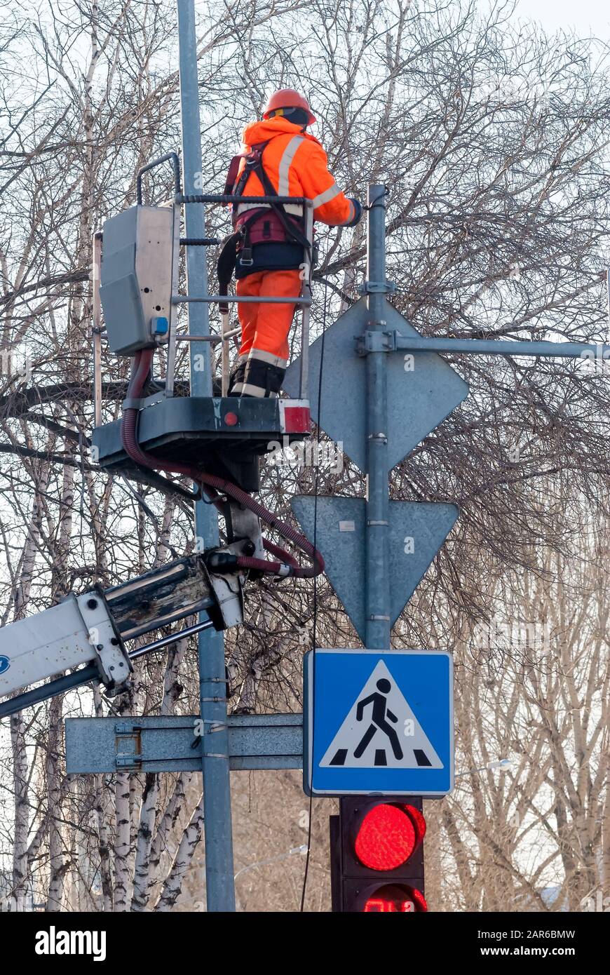 Workers mount a traffic light and road signs Stock Photo - Alamy