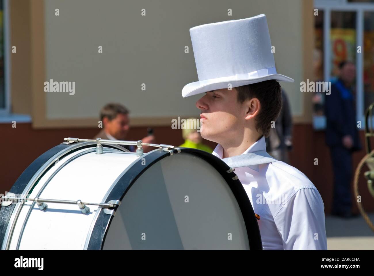 Drummer plays big drum in parade Stock Photo - Alamy