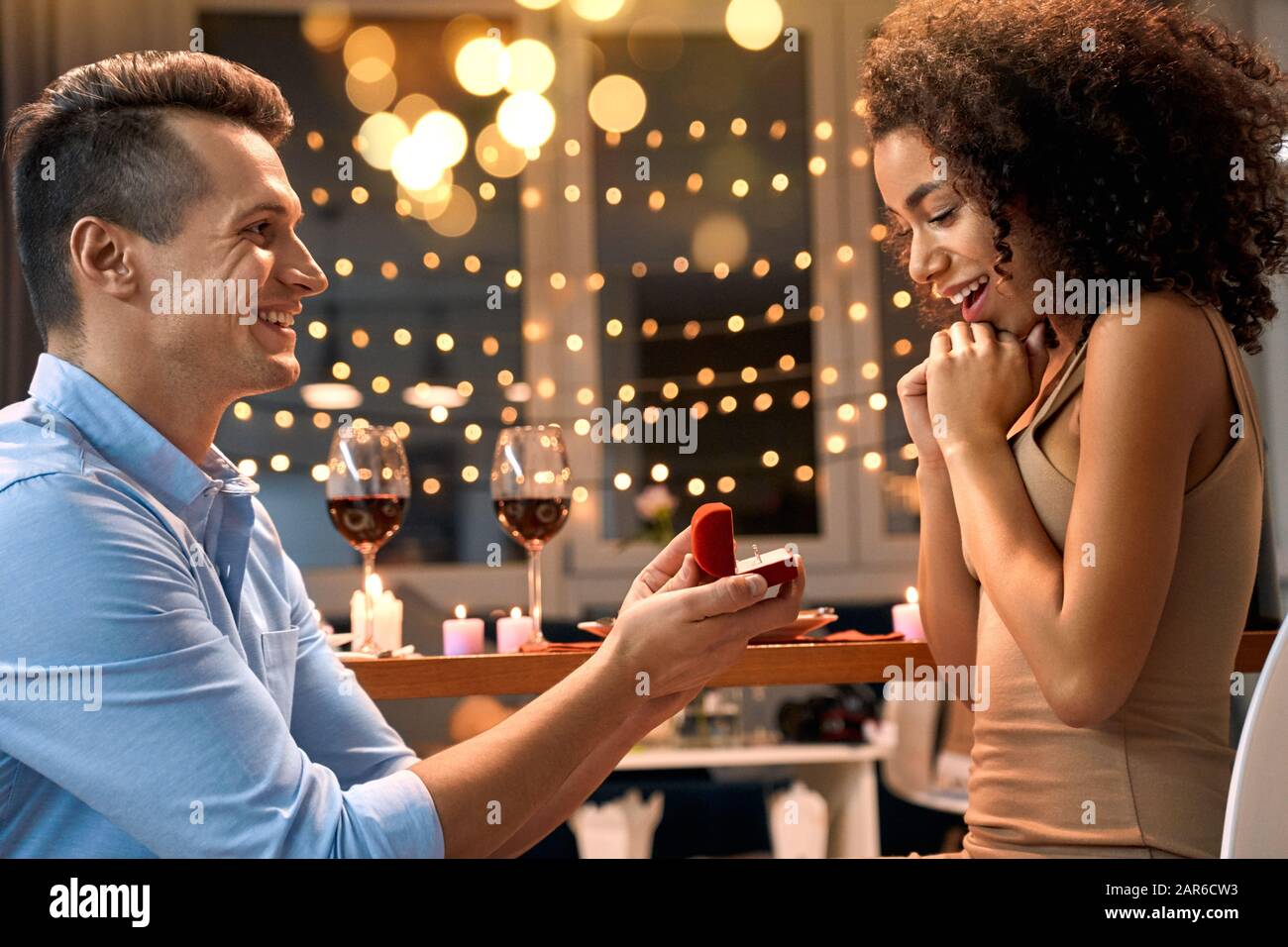 Romantic Date. Young multiethnic couple at home having dinner man ...