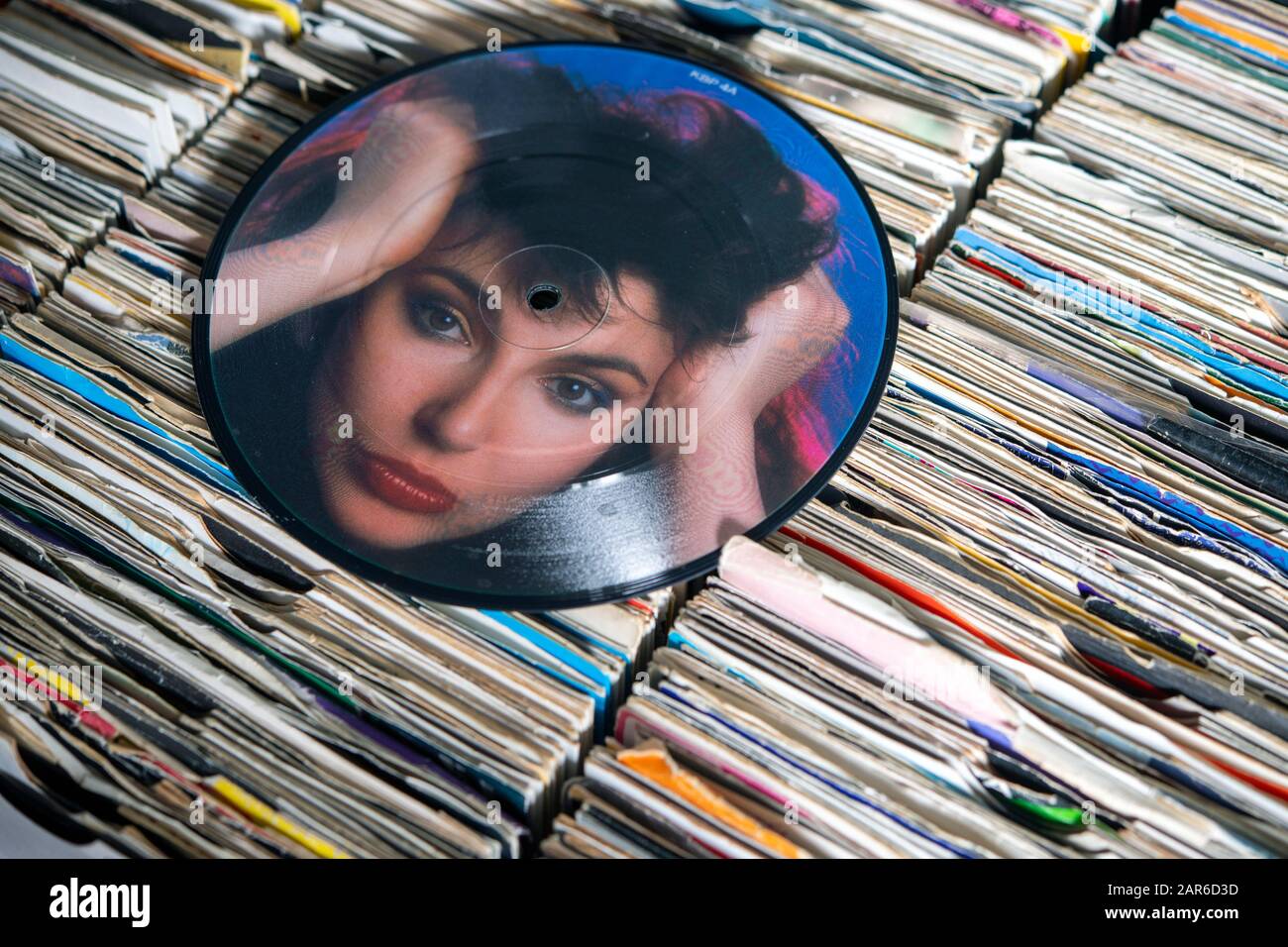 Kate Bush picture disc vinyl single on top of a collection of seven ...