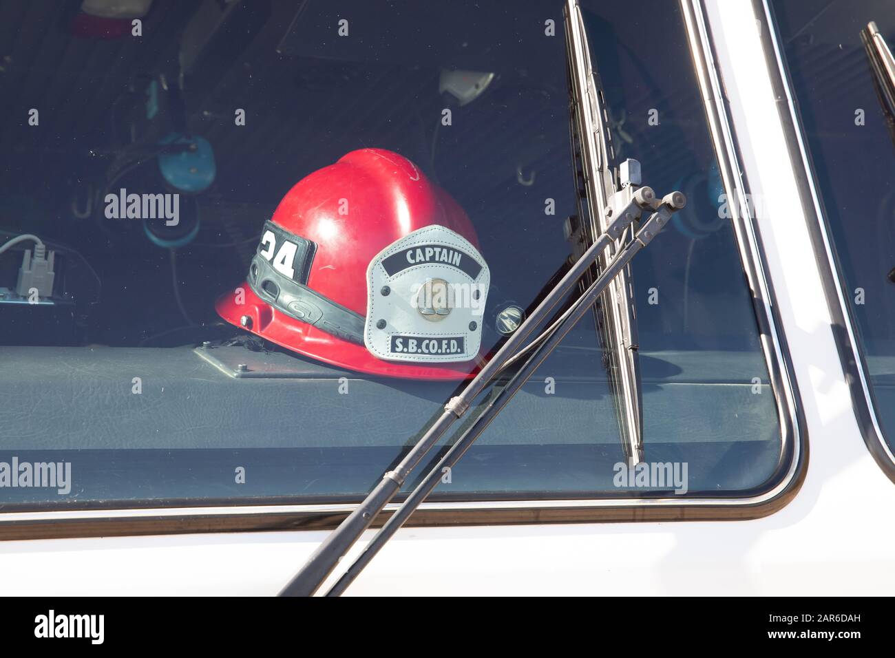 Red Captains helmet on the dashboard of a fire truck outside a Fire ...