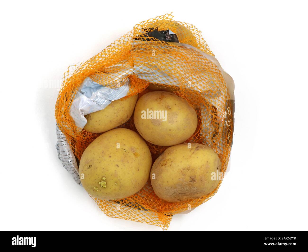 top view of potatoes in orange net on white background Stock Photo - Alamy