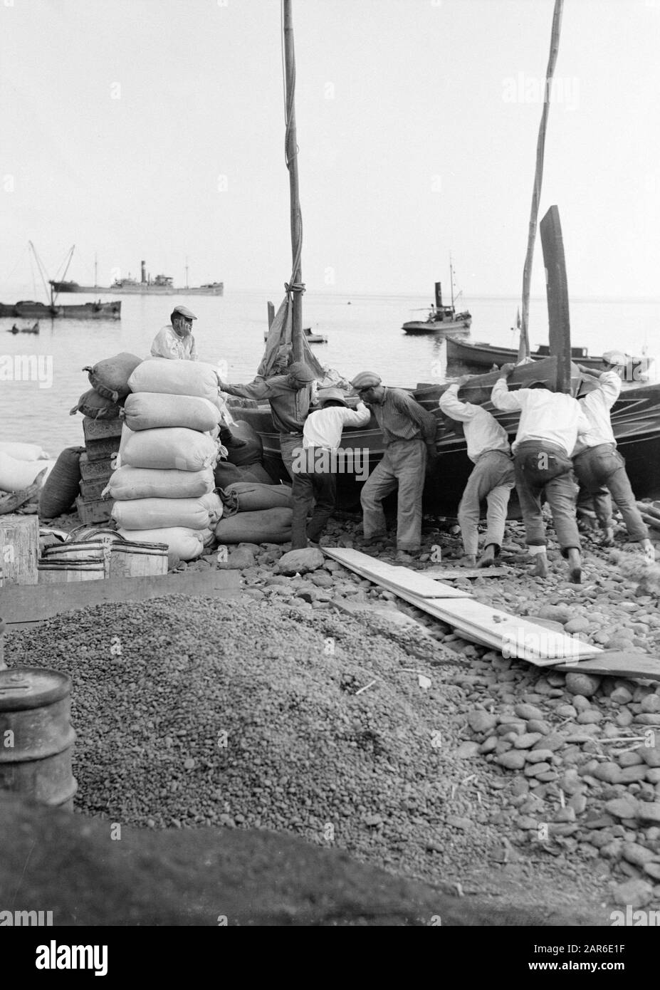 Madeira Men by a ship in the port of Funchal on Madeira Date: 1934 ...