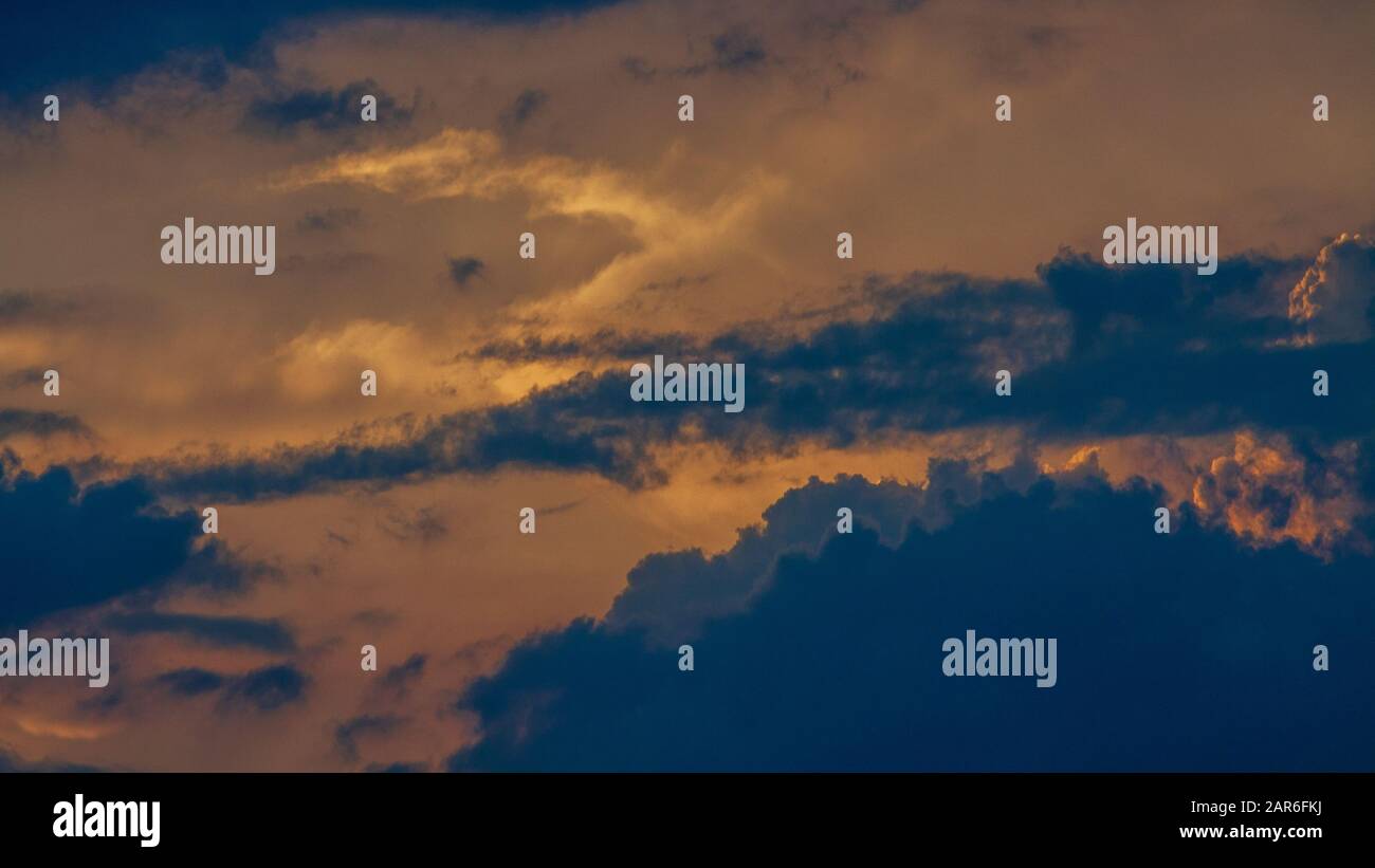 Dawn sky with dark clouds illuminated by the sun Stock Photo - Alamy
