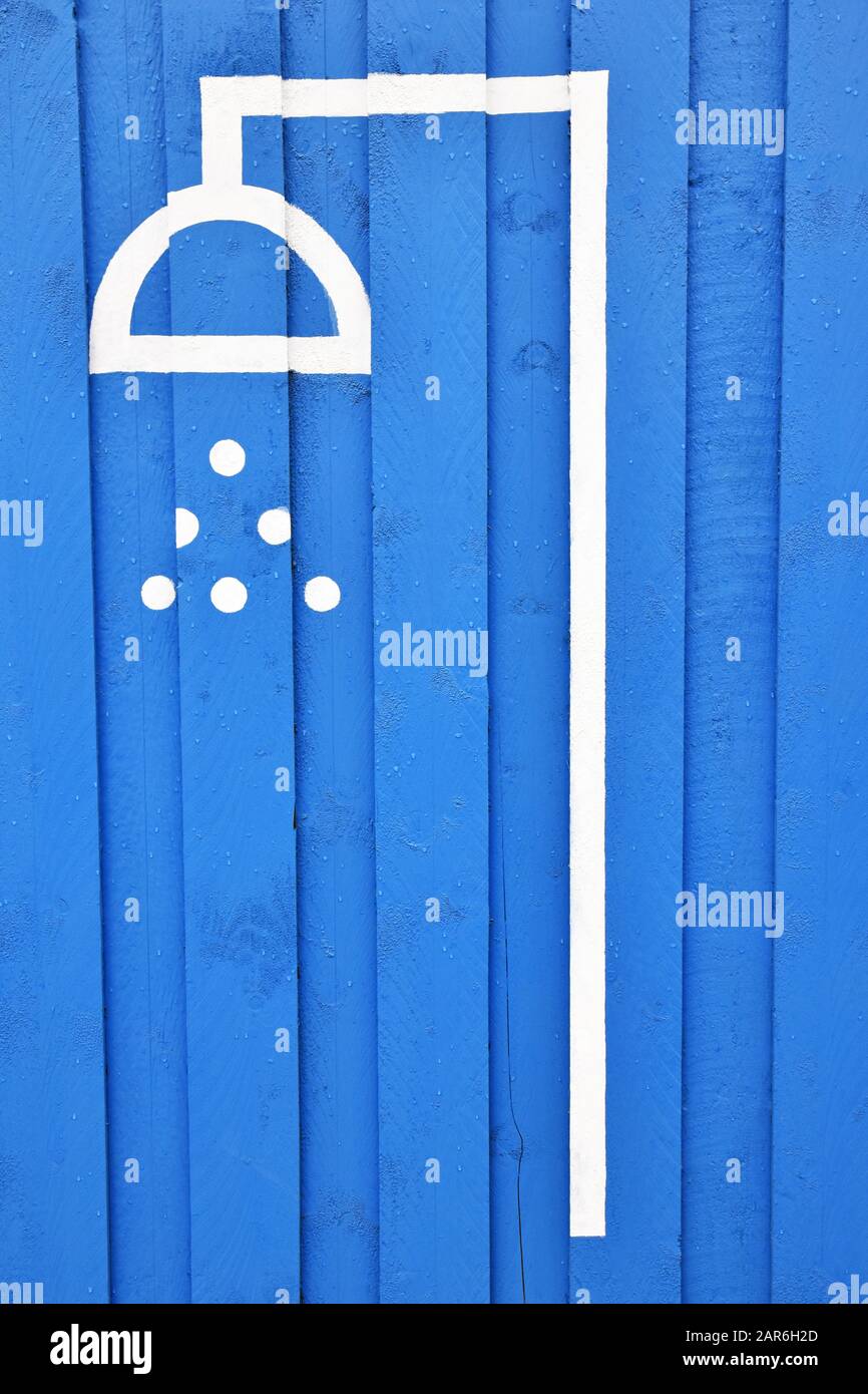 Handpainted shower signage on blue wooden boards, beachfront, isolated ...