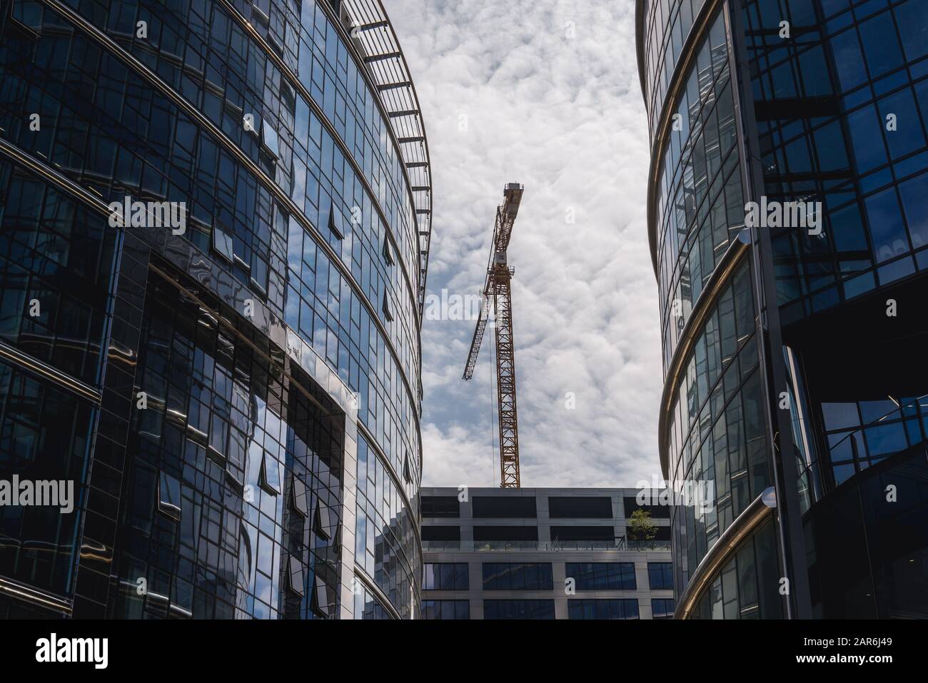 Building crane and Warsaw Spire office building in Warsaw, Poland Stock ...