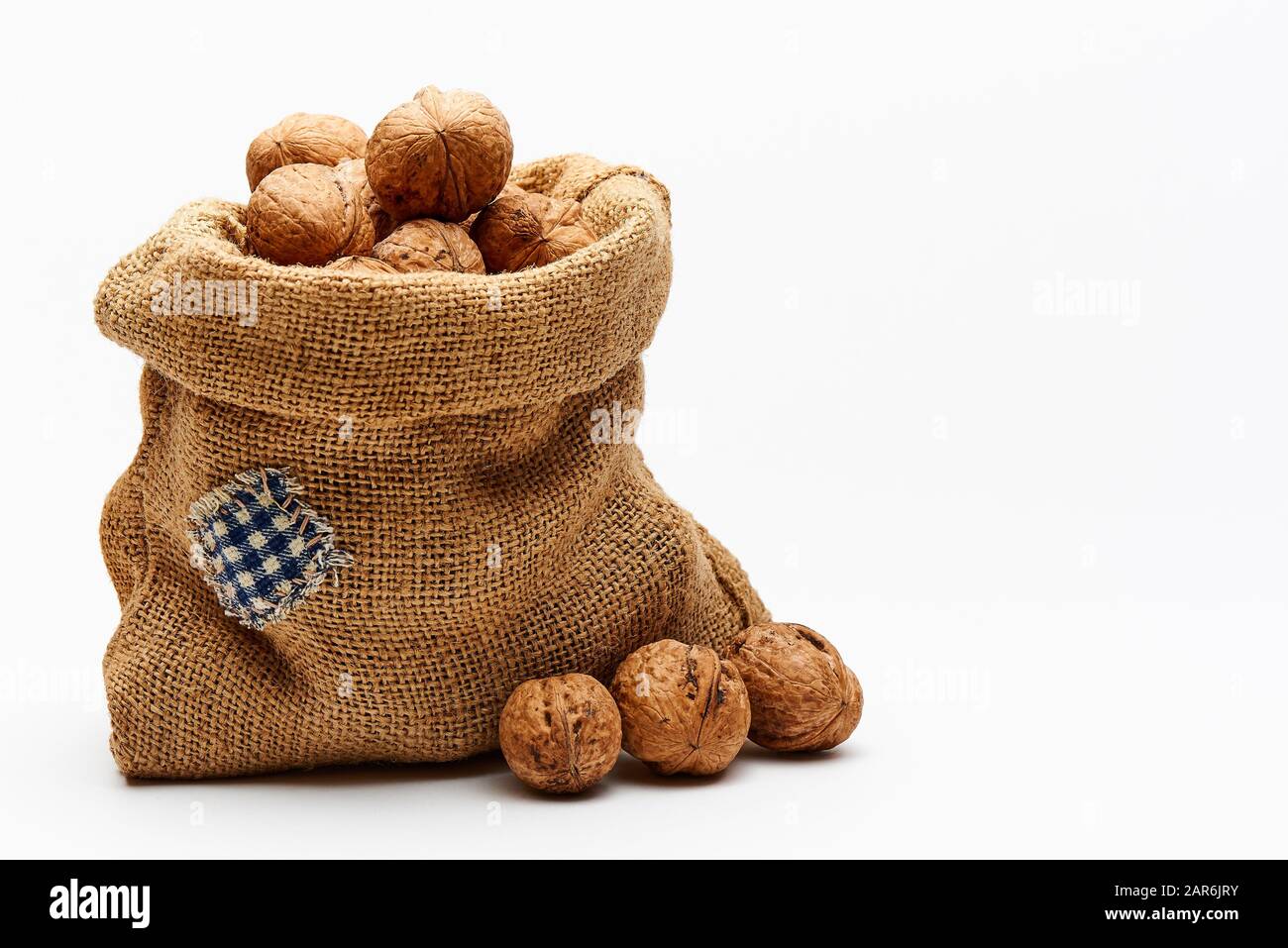 Bag with walnuts on a white background. Copy space Stock Photo - Alamy