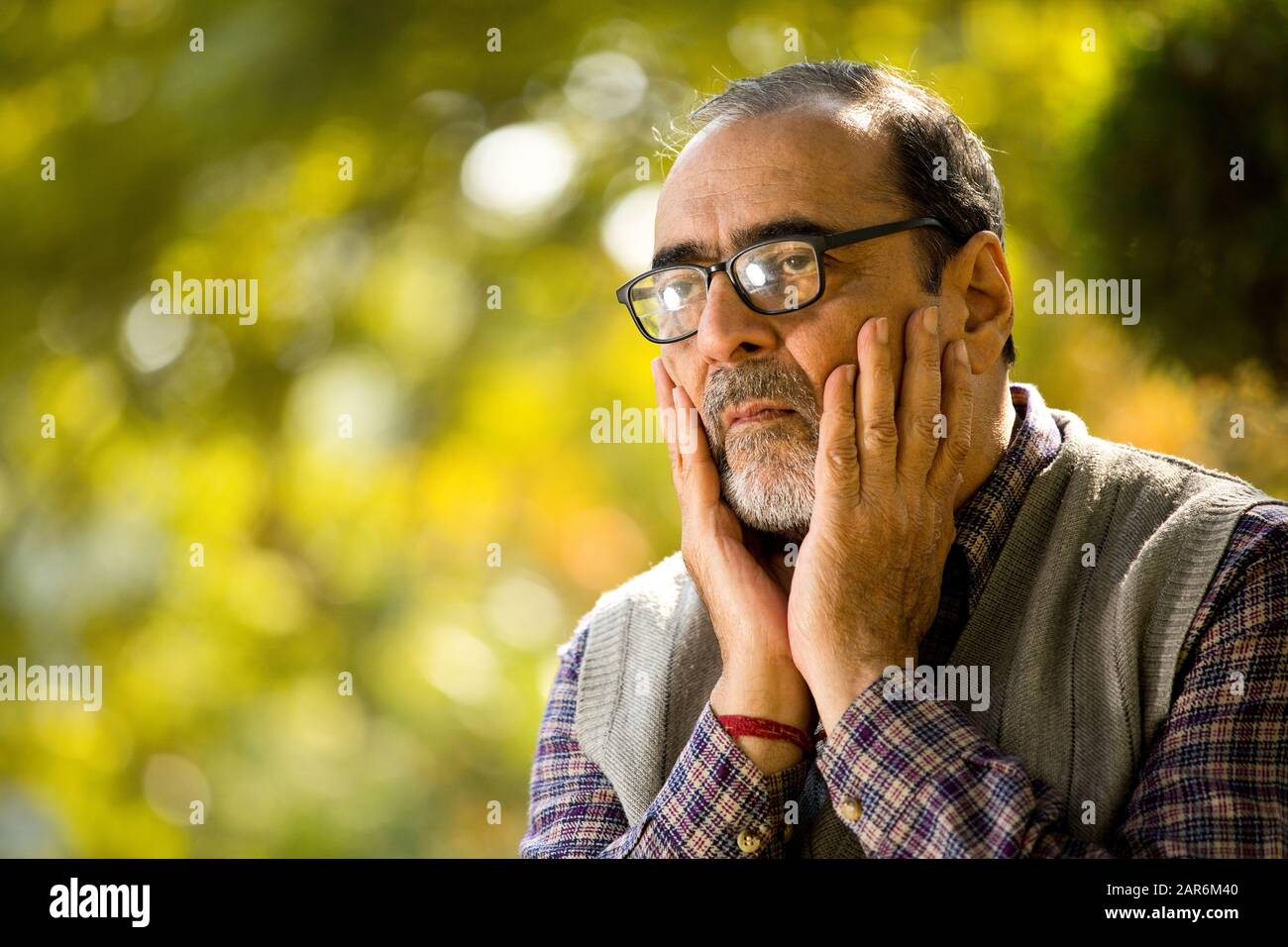 Thoughtful old man at park Stock Photo - Alamy