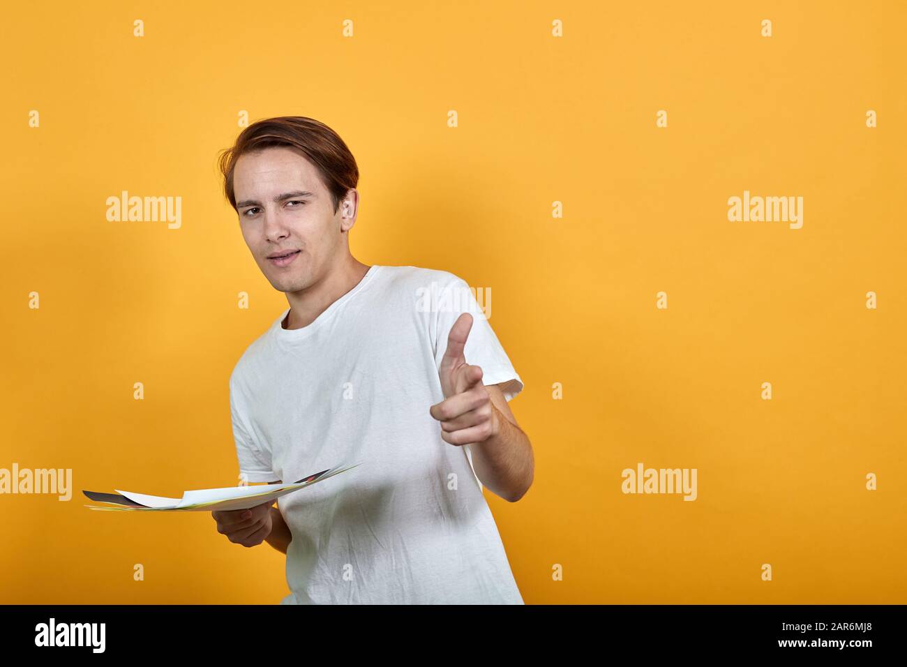 Young man holds several documents hi-res stock photography and images ...
