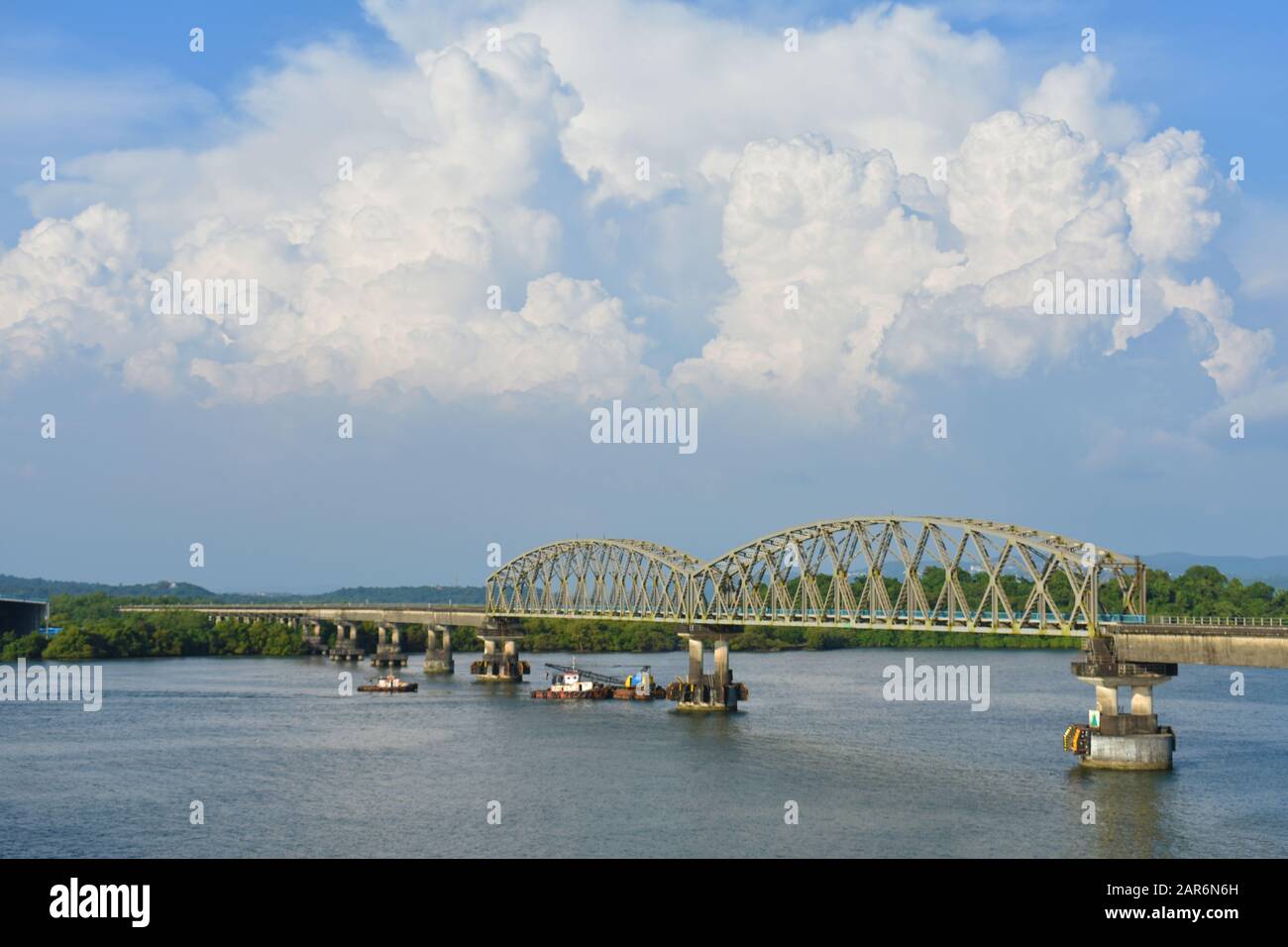 Beautiful clouds with a connecting bridge over a river Stock Photo - Alamy