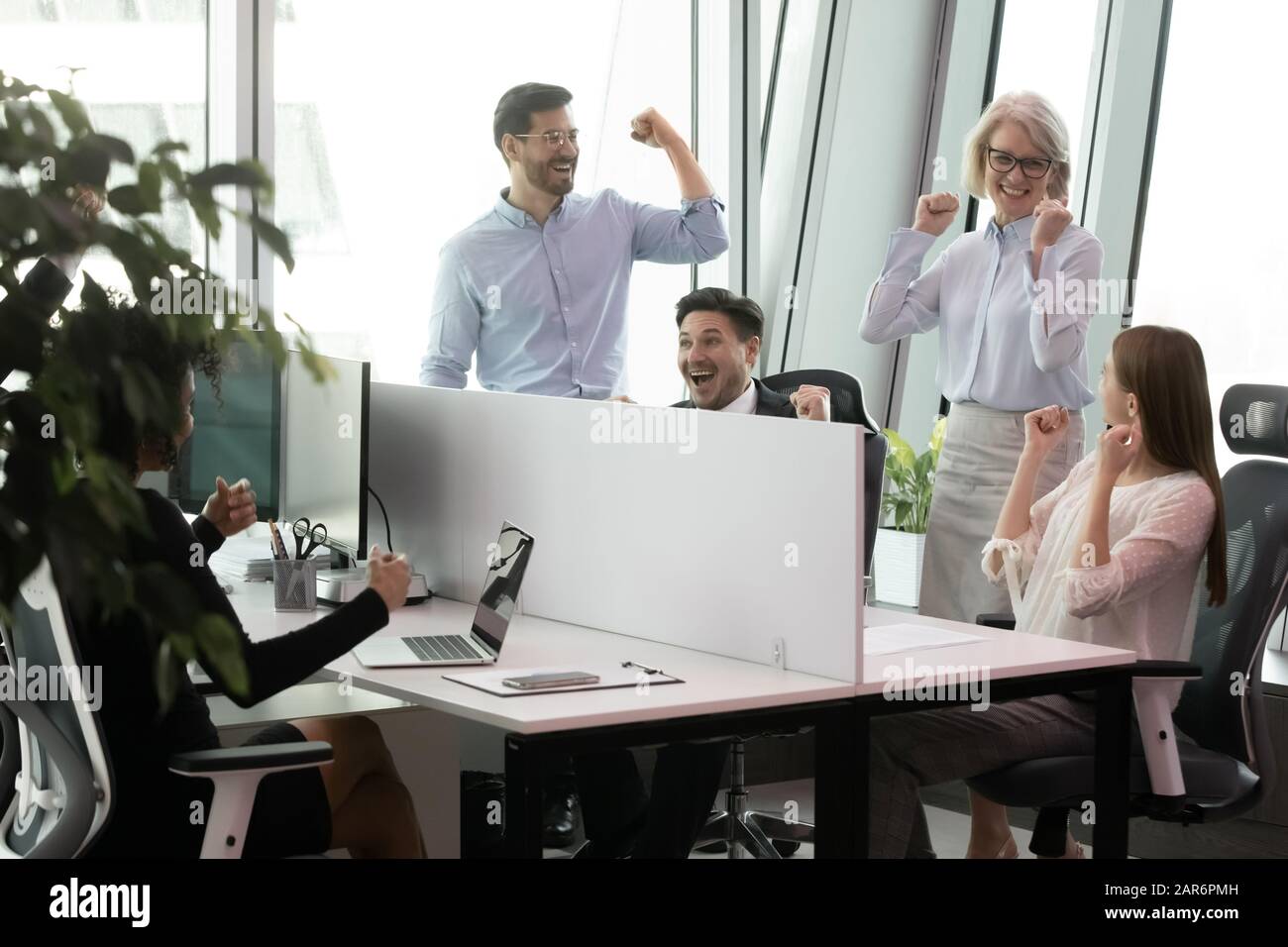 Overjoyed different ages business people celebrating corporate win ...