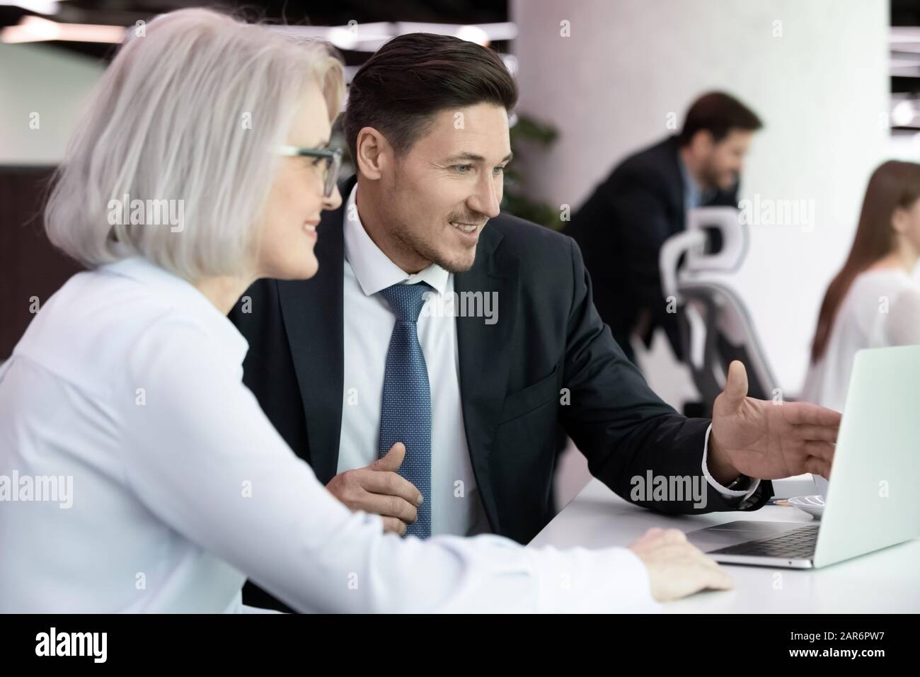 Smiling businessman showing project presentation to mature client Stock ...