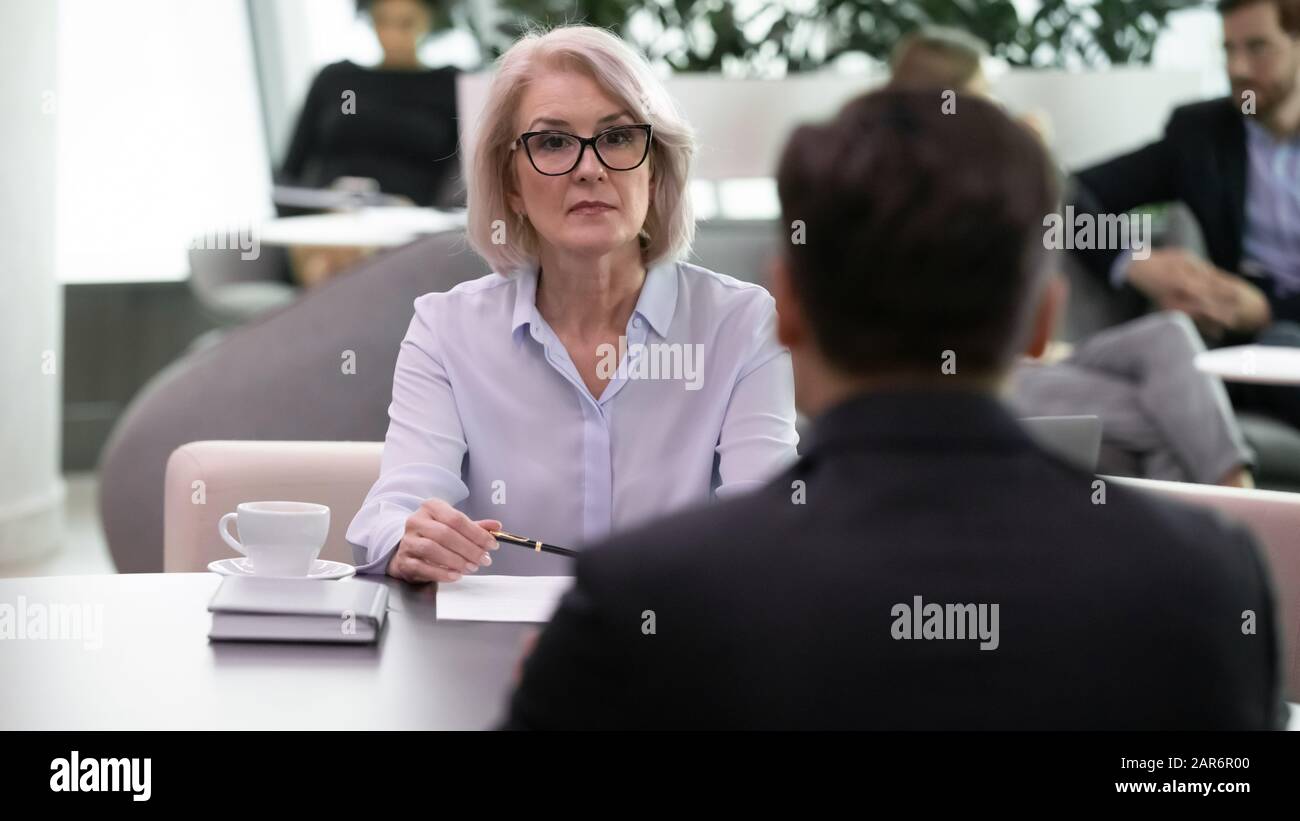Serious middle aged female hr manager conducting interview with ...