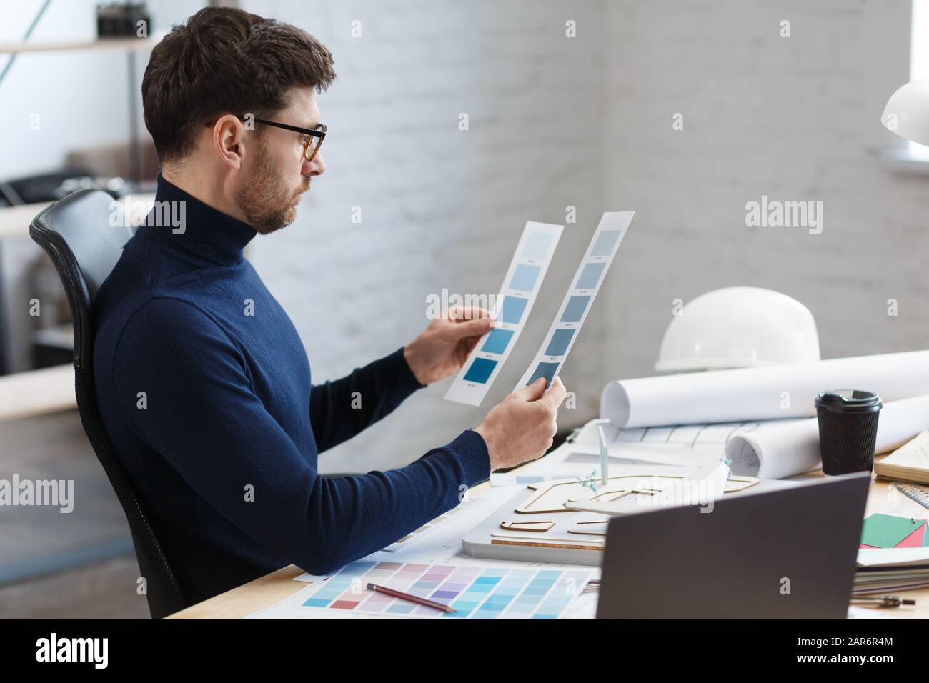 Architect working in office with color palette. Engineer select colors ...