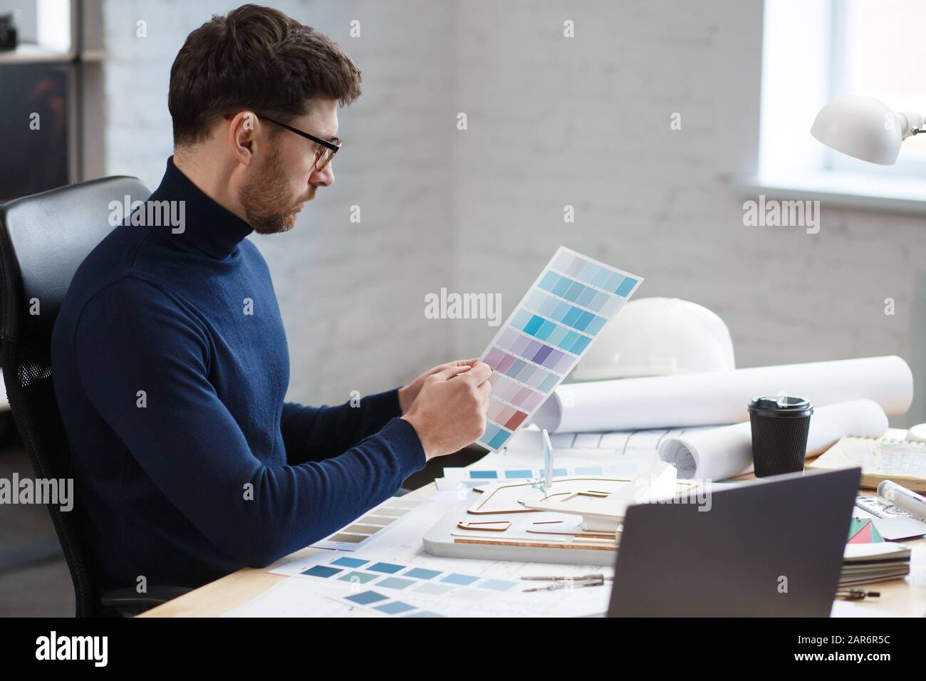 Architect working in office with color palette. Engineer select colors ...