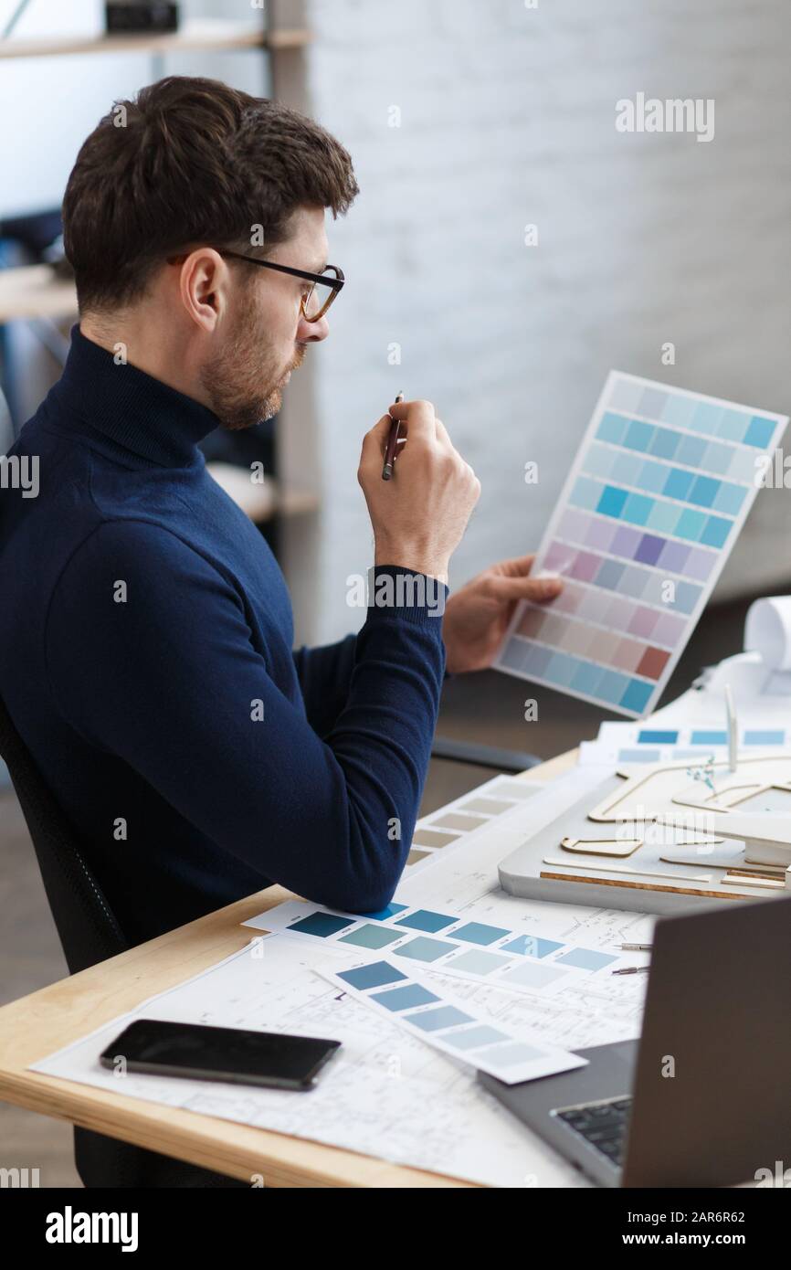Architect working in office with color palette. Engineer select colors ...