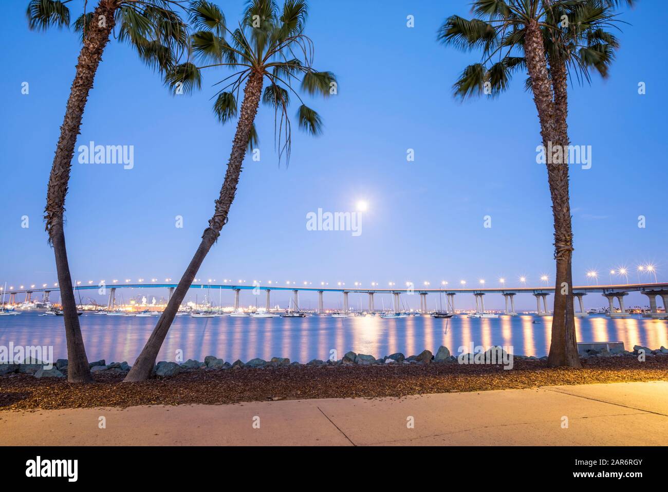 The Moon rising over the Coronado Bridge and San Diego Harbor at night ...