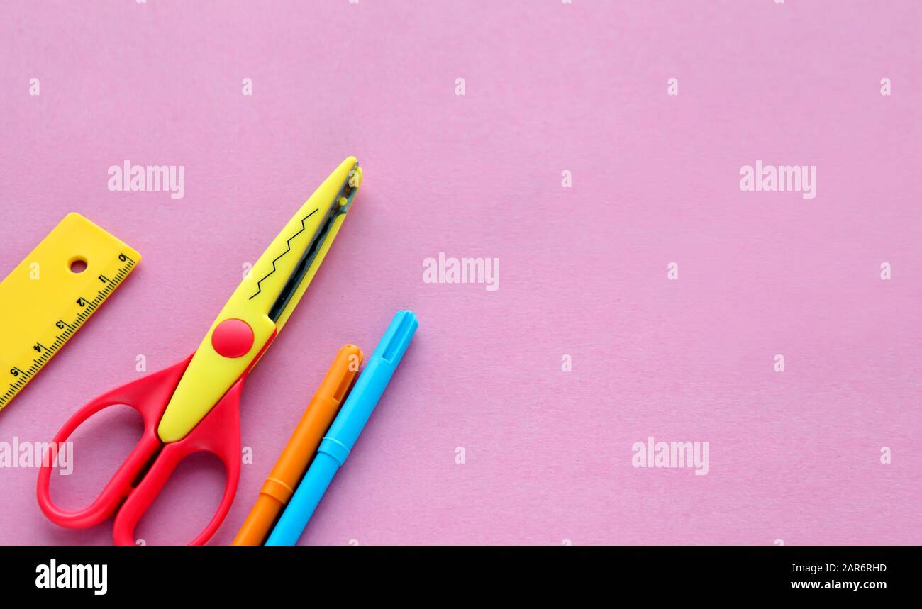 scissors, ruler and crayons on a pink background. Creative, fashionable ...