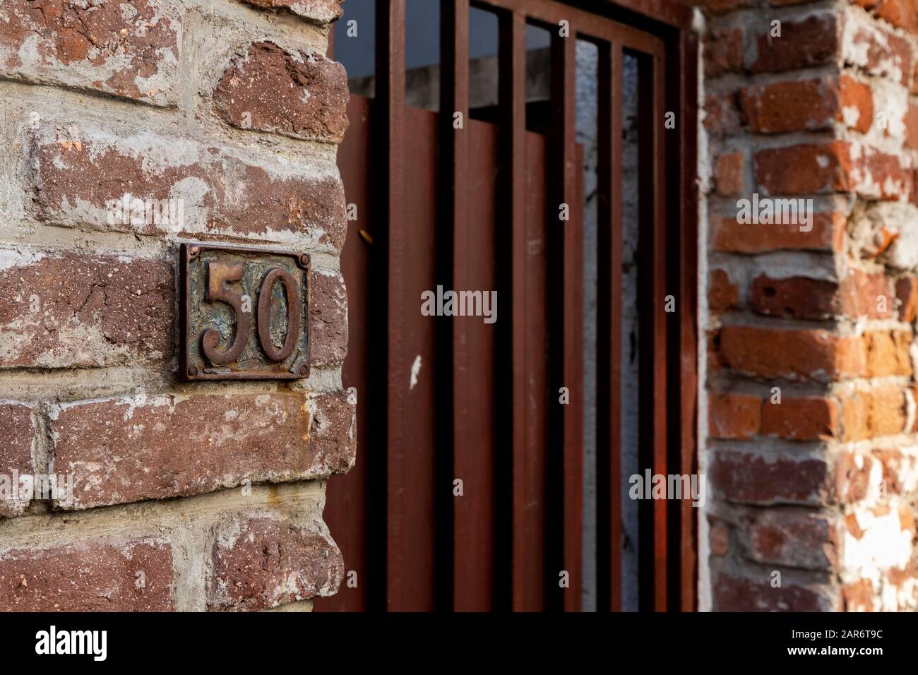 Grunge metal house plate with 50 on the exterior wall, The number 50 on ...