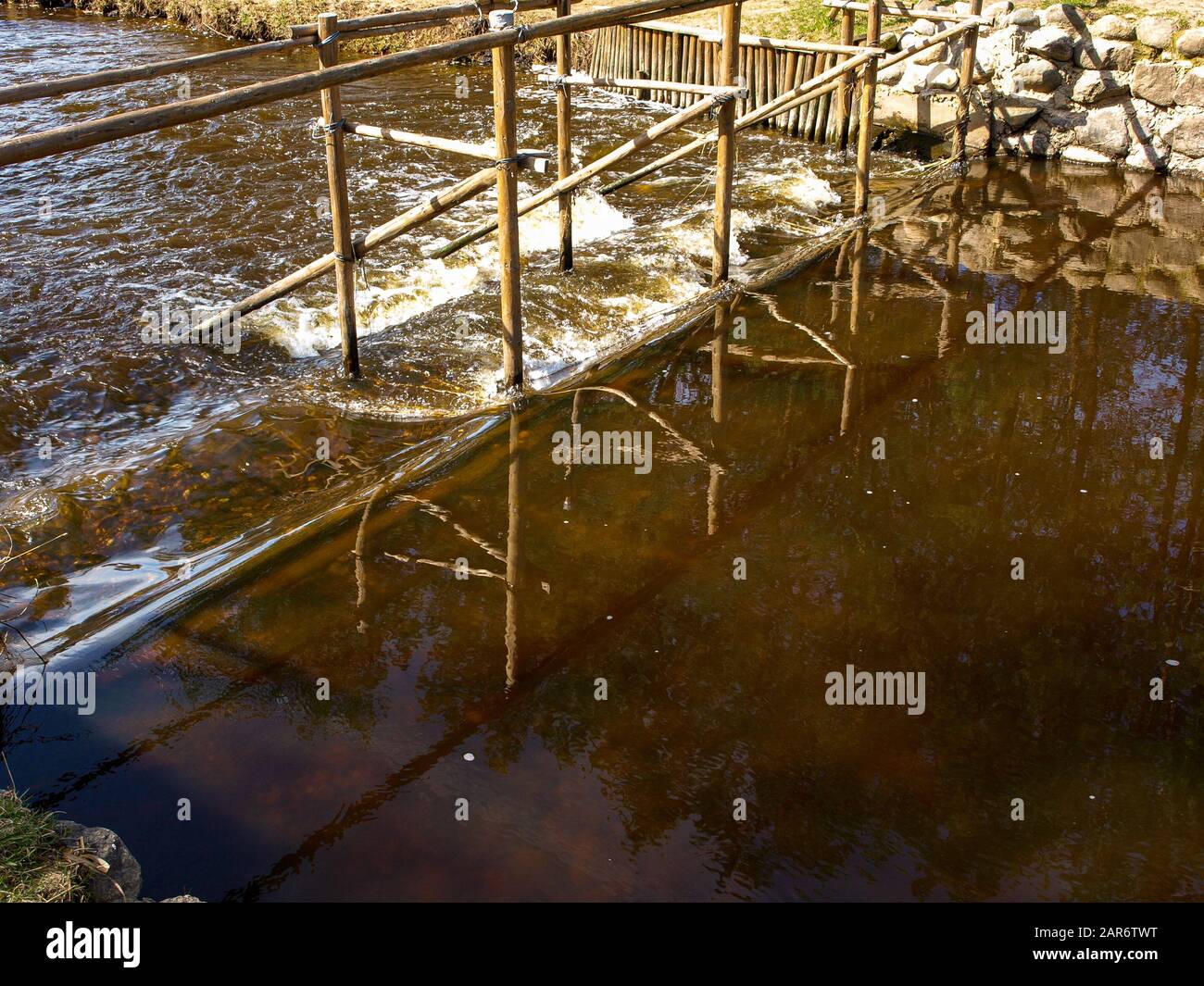 picture with wooden structures on the river Stock Photo - Alamy