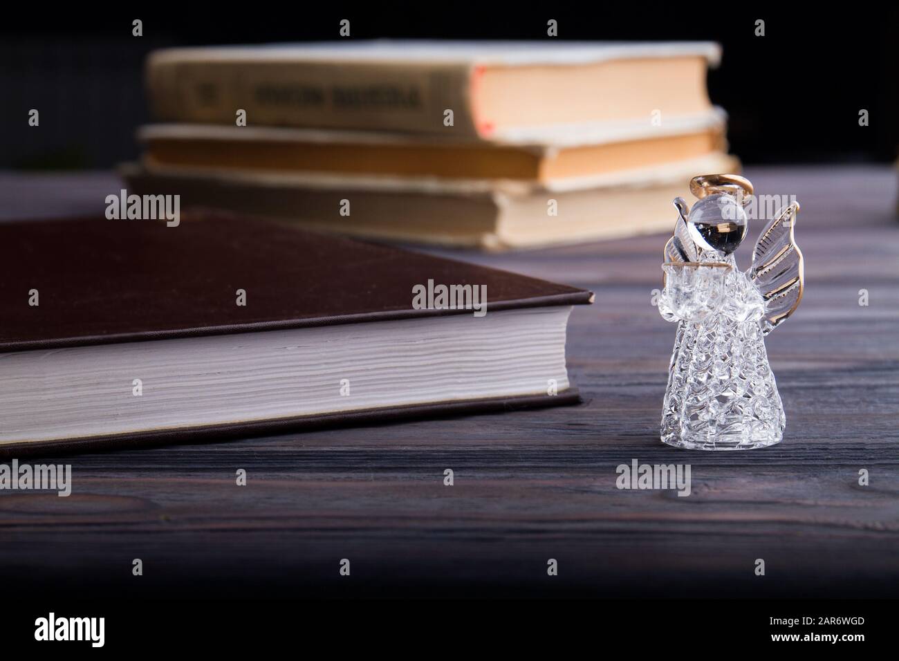 Glass angel and books Stock Photo - Alamy
