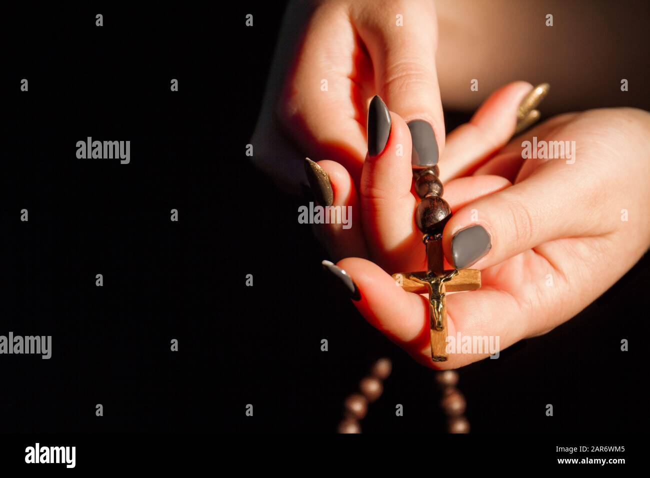 Female hands with crucifix cross close-up Stock Photo - Alamy