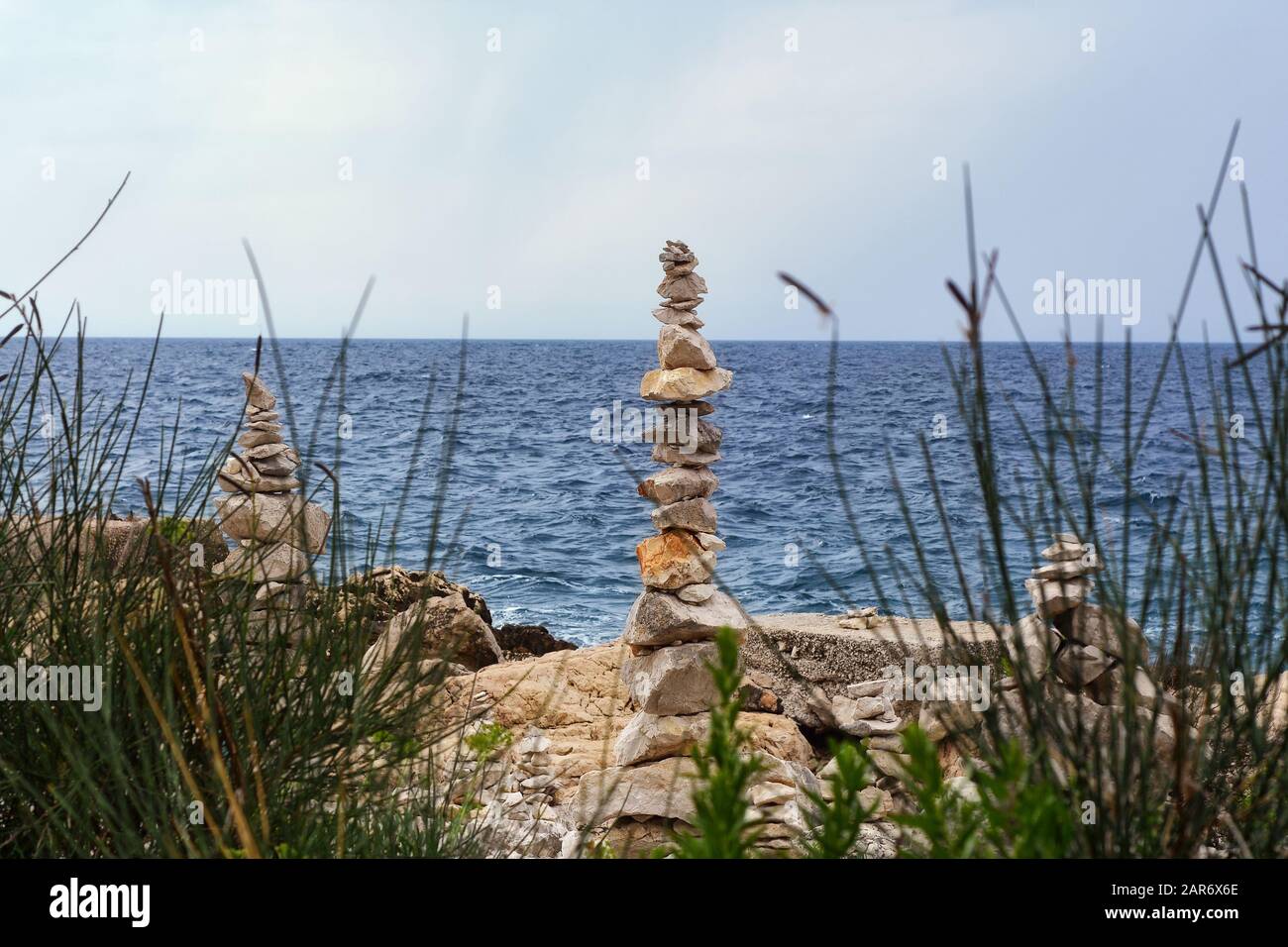 Stone pyramids on the rocky coast of the Adriatic sea in Croatia ...