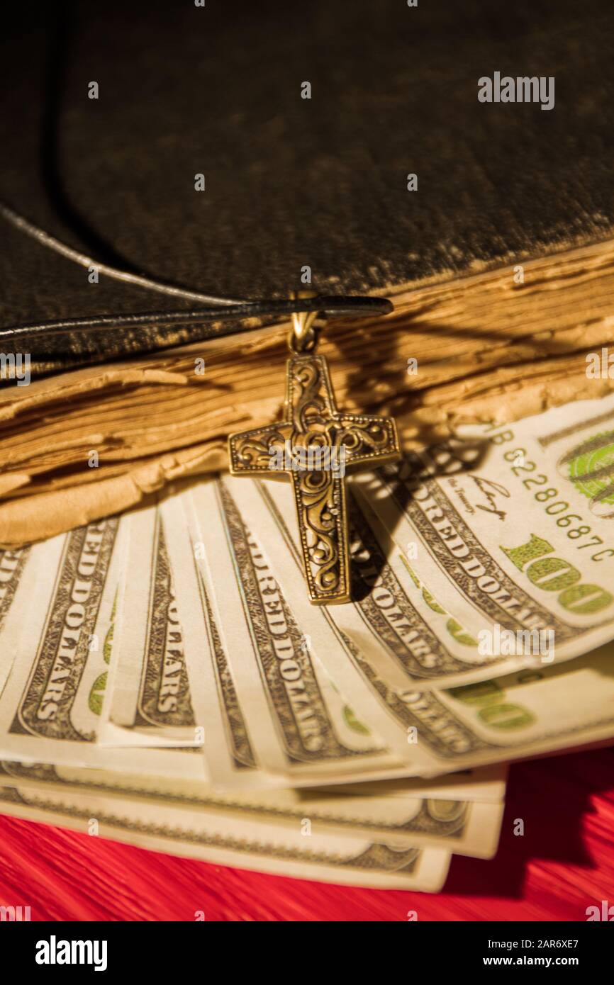 Money in book, church tethe concept Stock Photo - Alamy