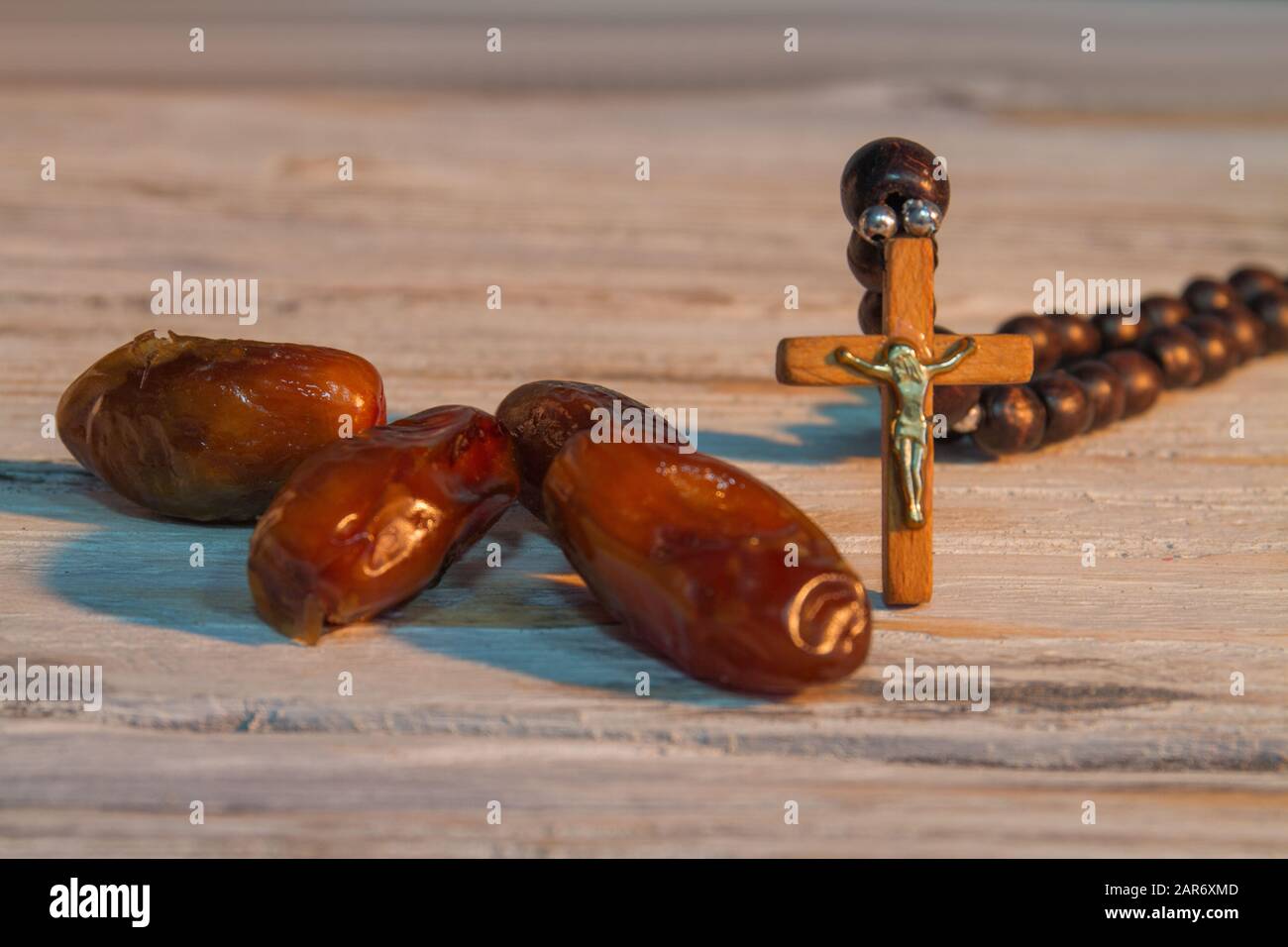 Date fruits and rosary with cross crucifix Stock Photo - Alamy