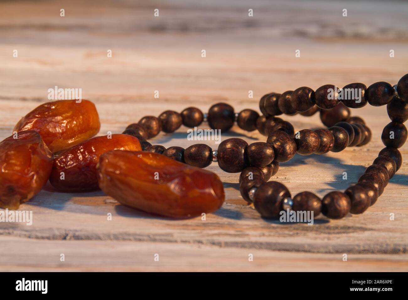 Bunch of dates and bead necklace close up Stock Photo - Alamy