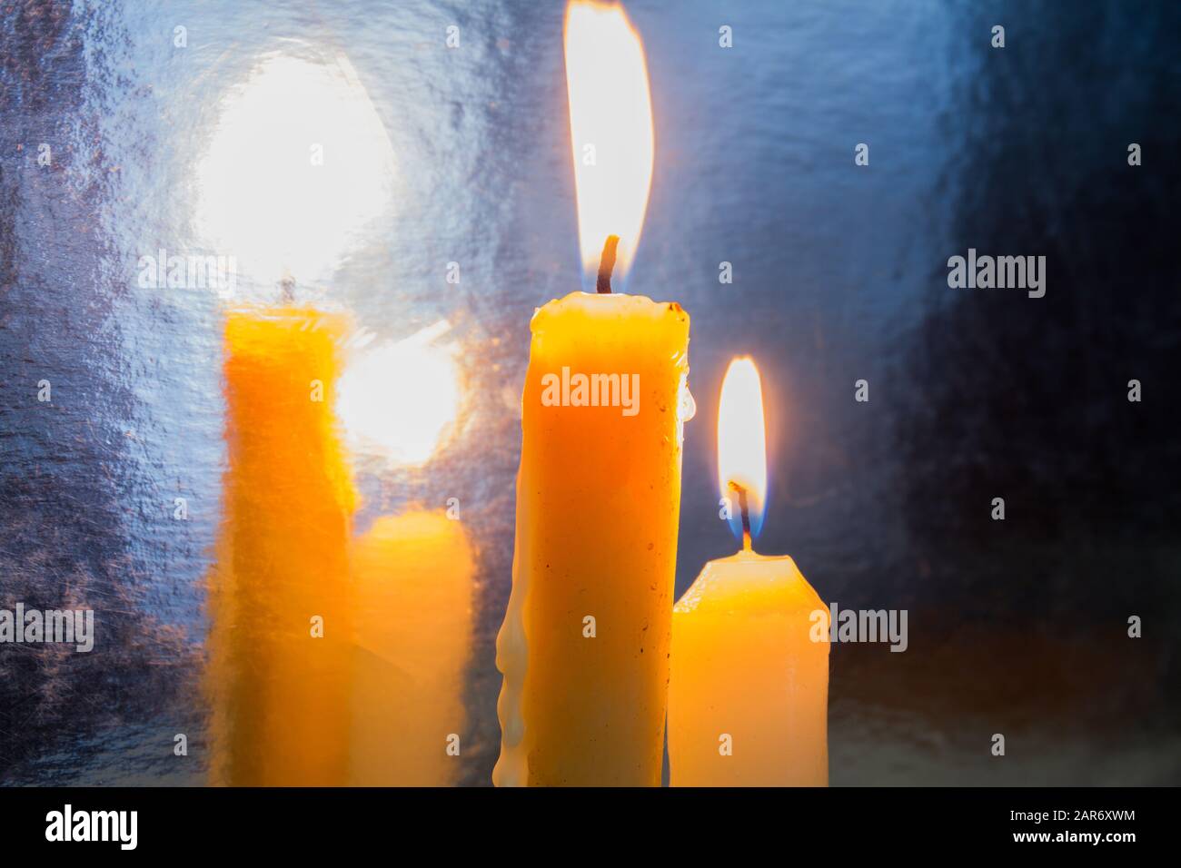 Two burning candles and their reflection Stock Photo - Alamy