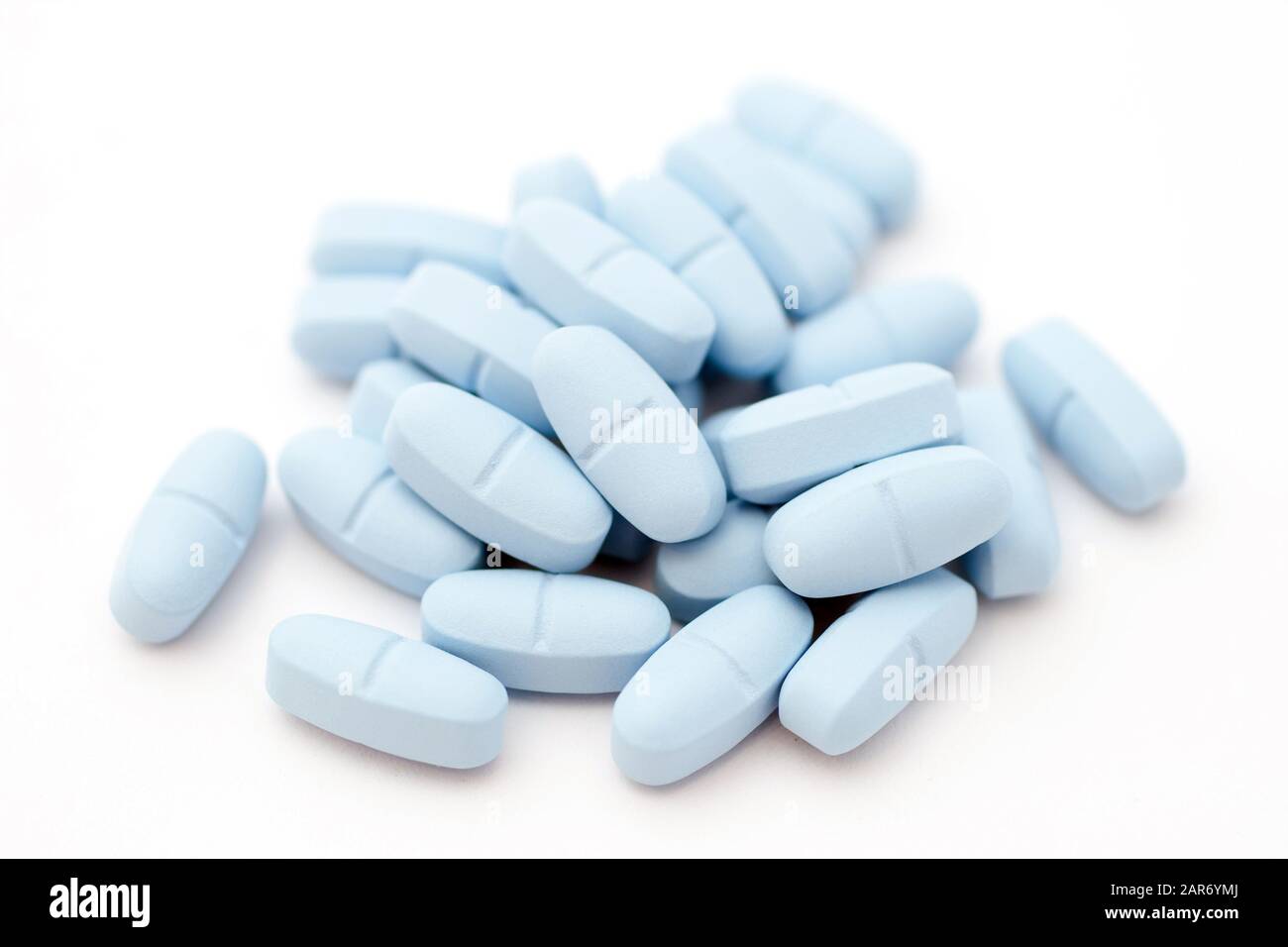 A group of blue pills on white background Stock Photo - Alamy