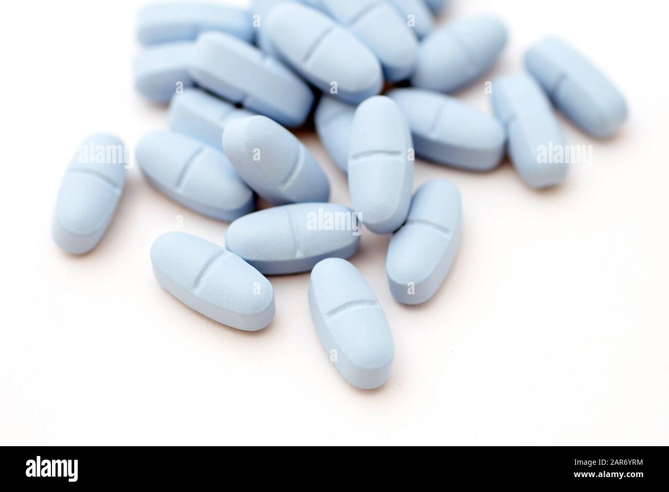 A group of blue pills on white background Stock Photo - Alamy