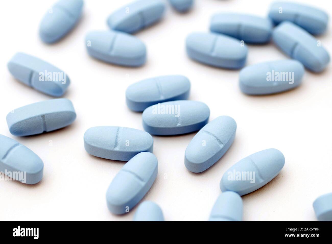 A group of blue pills on white background Stock Photo - Alamy
