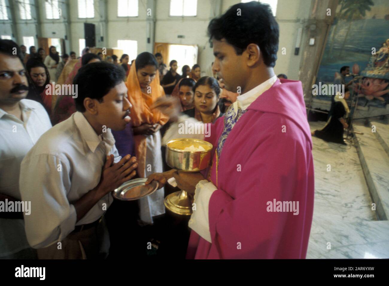 India Priest giving communion, Kerala Stock Photo - Alamy