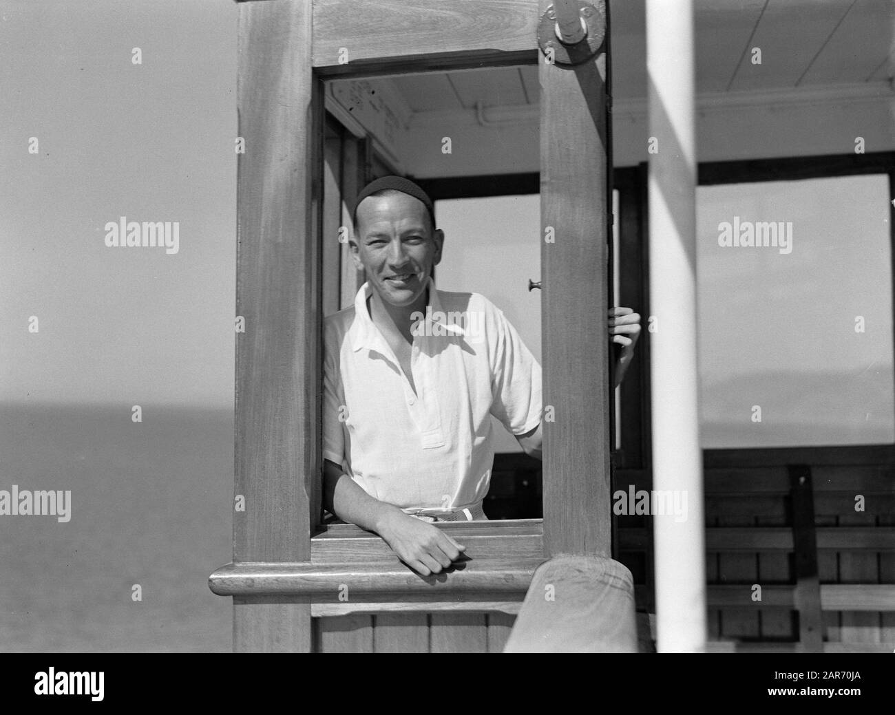 On board the MS Dempo Noël Coward looks out window of the bridge Date ...