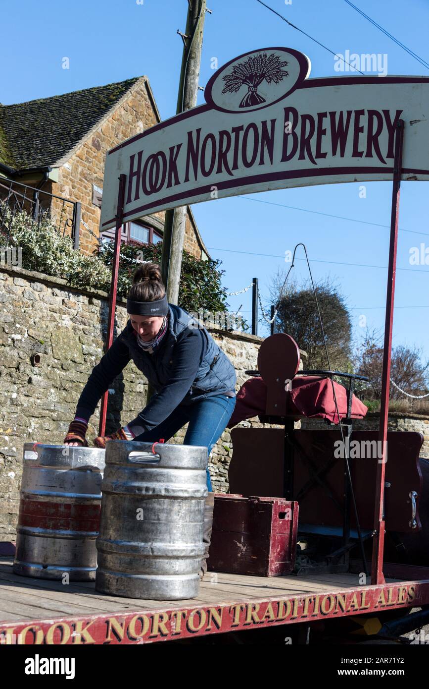 Erzsebet Csak, a dray delivery assistant. helps load several barrels of ...