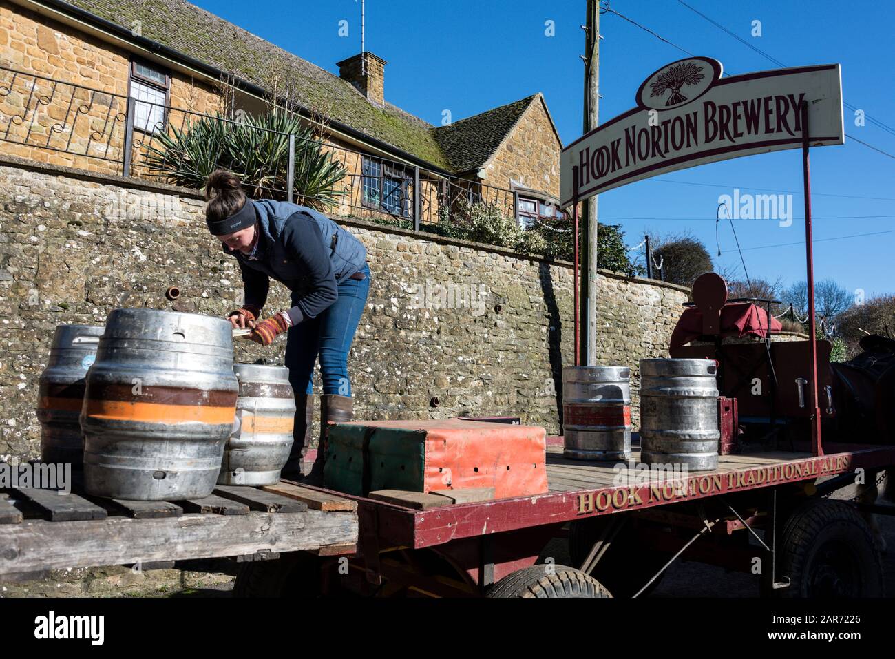 Erzsebet Csak, a dray delivery assistant. helps load several barrels of ...