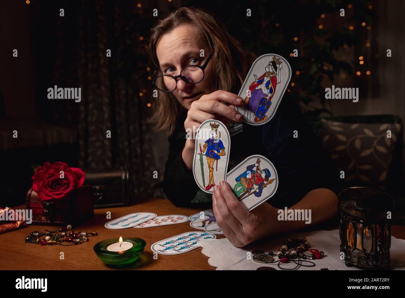 Mature woman is guessing on the cards. The fortuneteller holds a ...