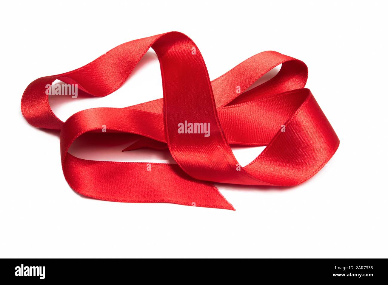 simply red ribbon roll on white background Stock Photo - Alamy